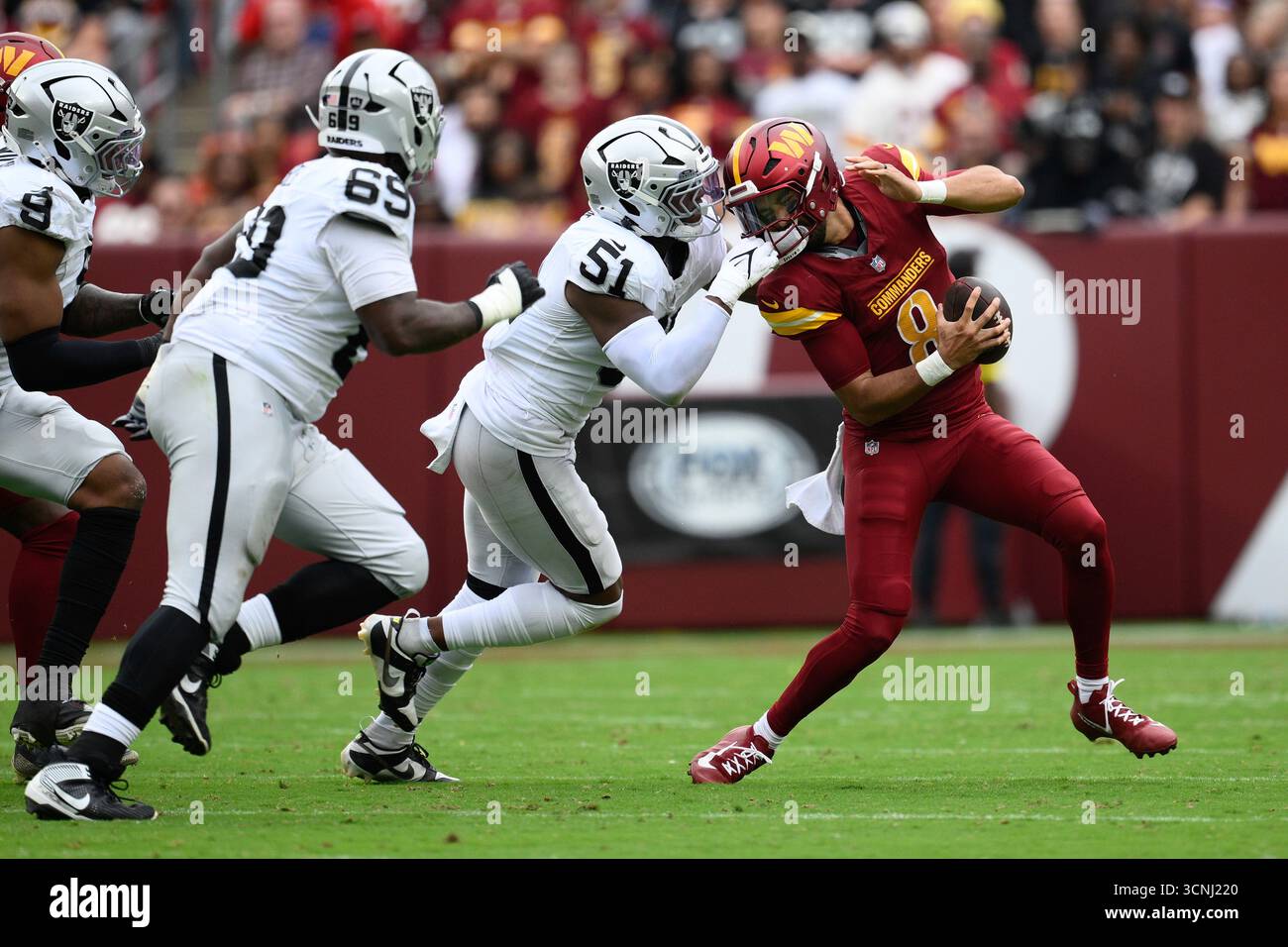Las Vegas Raiders defensive end Malcolm Koonce (51) face masks ...