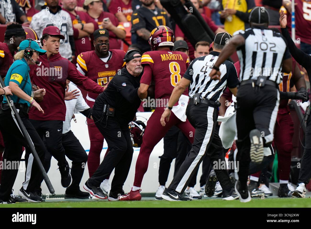 Washington Commanders Dan Quinn is run into on the sideline during the ...