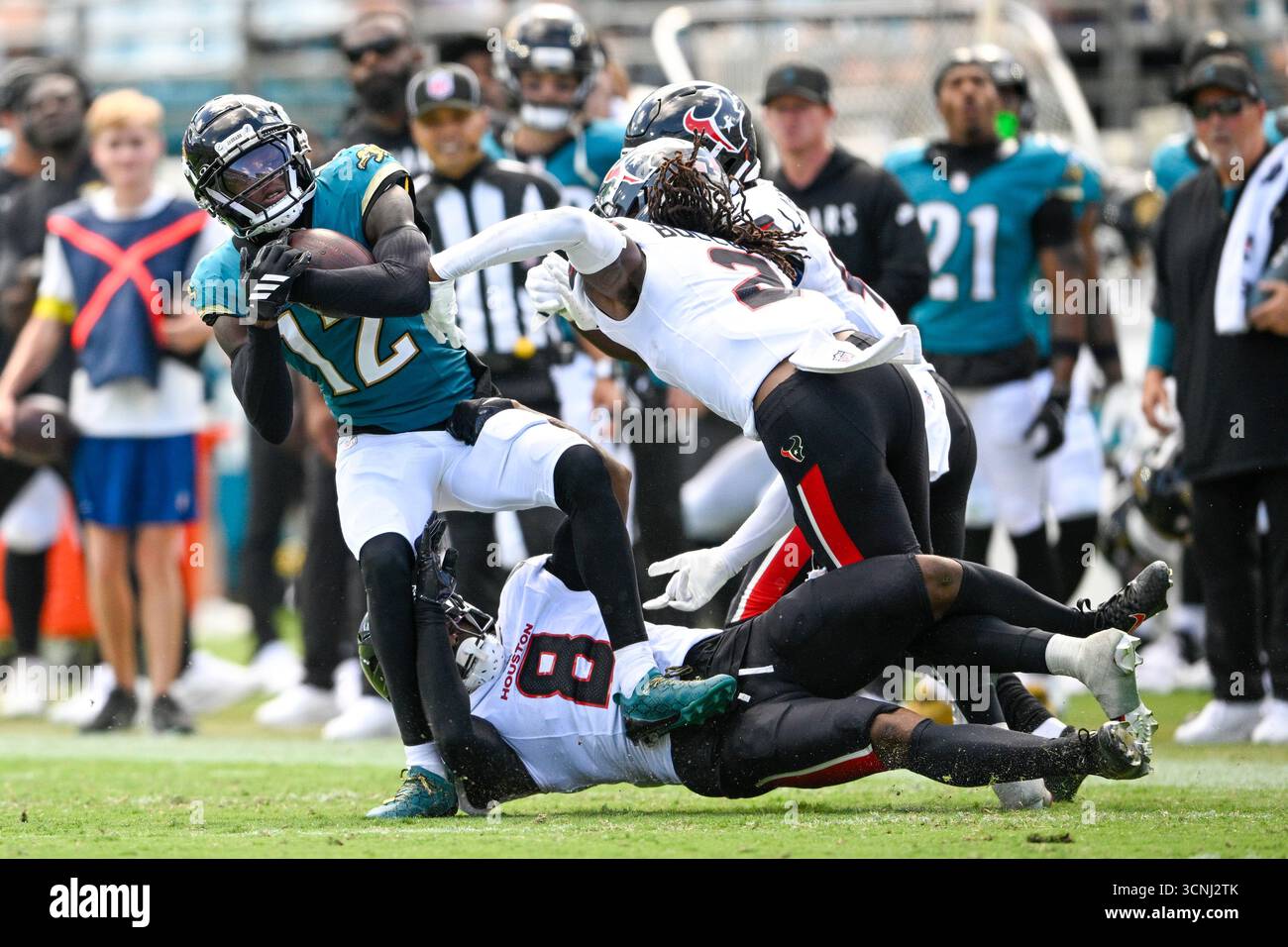 Jacksonville Jaguars wide receiver Travis Hunter (12) is tackled by ...