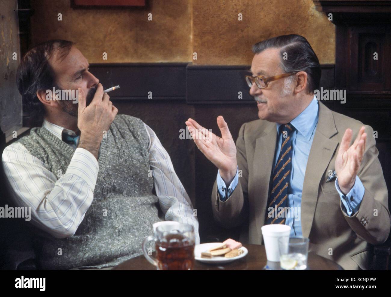John Cleese and Alan Whicker on the set of the BBC publicity advert ...