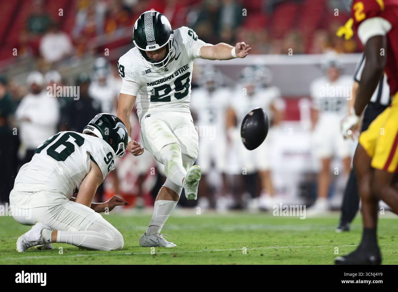 Michigan State place kicker Martin Connington (29) kicks the ball for ...