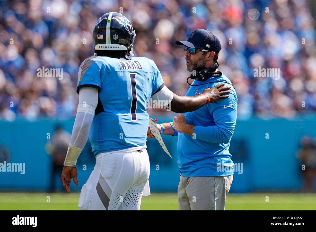 Tennessee Titans head coach Brian Callahan talks with quarterback Cam ...