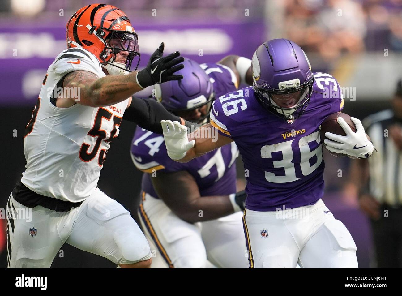 Minnesota Vikings' Zavier Scott (36) is chased by Cincinnati Bengals' Logan Wilson (55) during ...