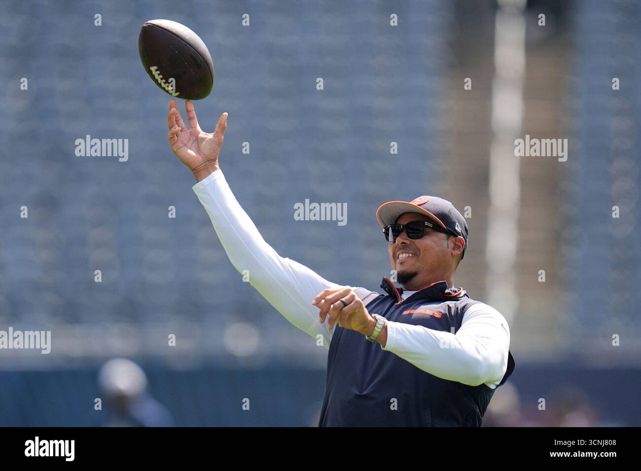 Chicago Bears general manger Ryan Poles tosses a ball as the team warms ...