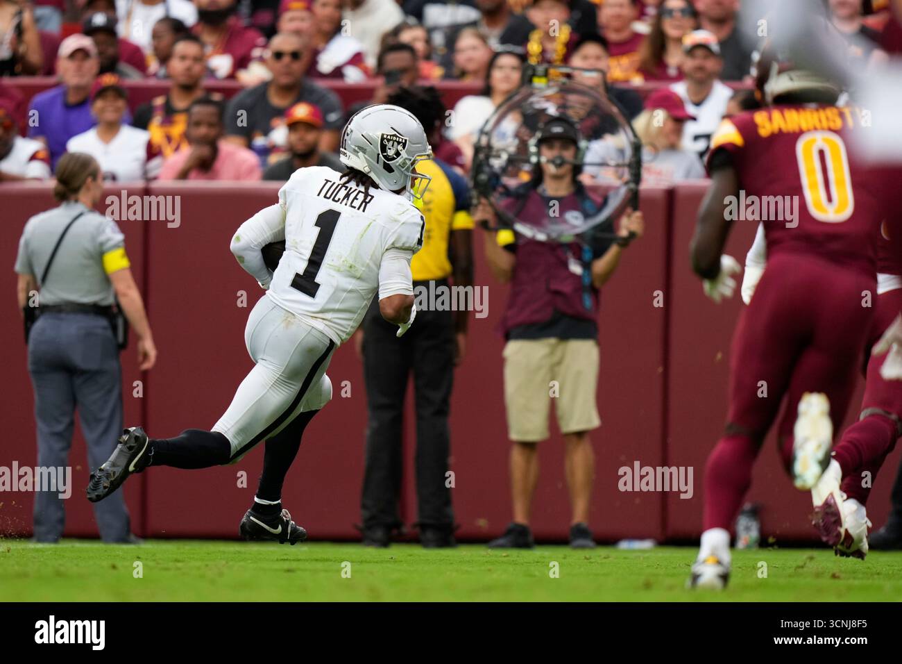 Las Vegas Raiders wide receiver Tre Tucker (1) runs for a touchdown ...