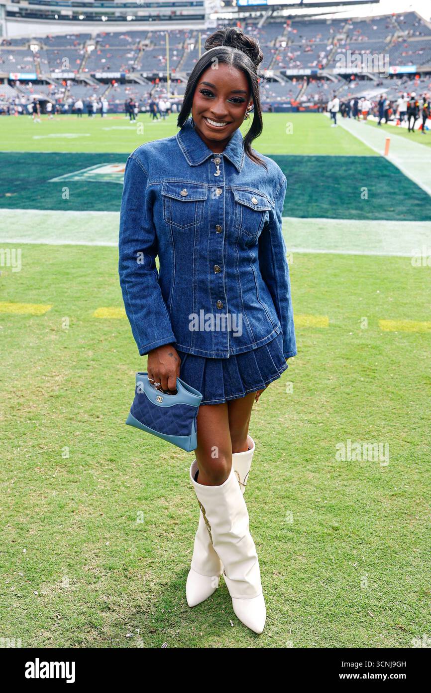 Simone Biles poses for a photo before an NFL football game between the ...