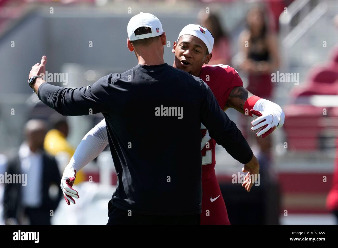 Arizona Cardinals head coach Jonathan Gannon, left, hugs safety Dadrion ...