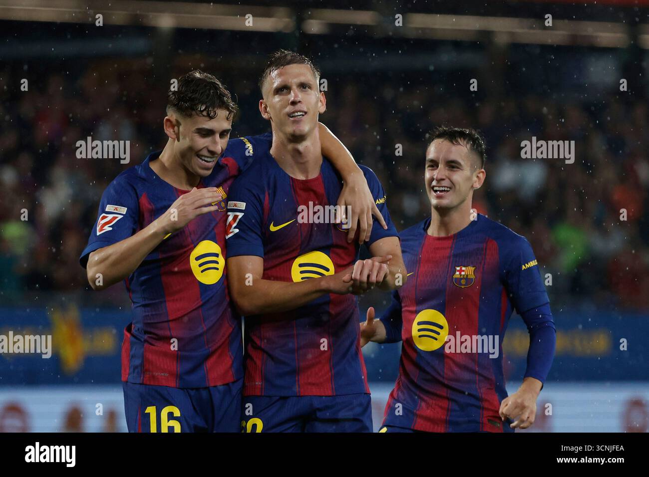 Barcelona's Dani Olmo, center, celebrates his side's third goal during ...