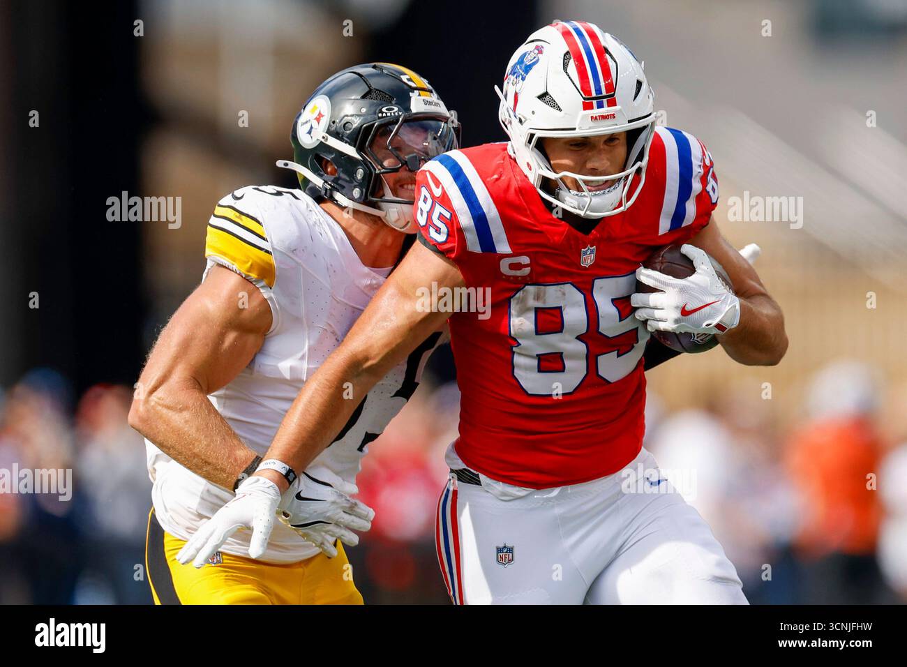 New England Patriots tight end Hunter Henry (85) is tackled by ...