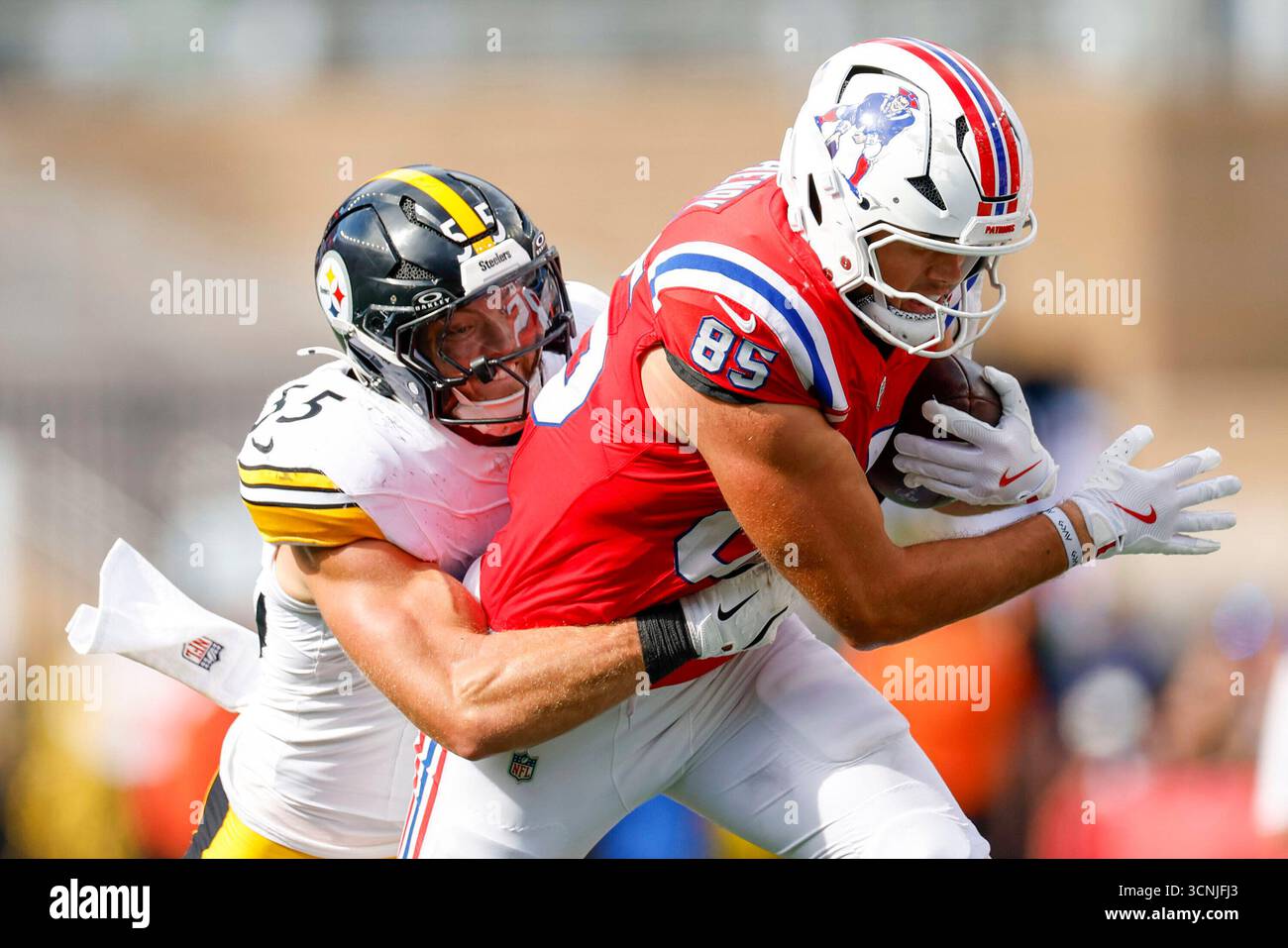 New England Patriots tight end Hunter Henry (85) is tackled by ...