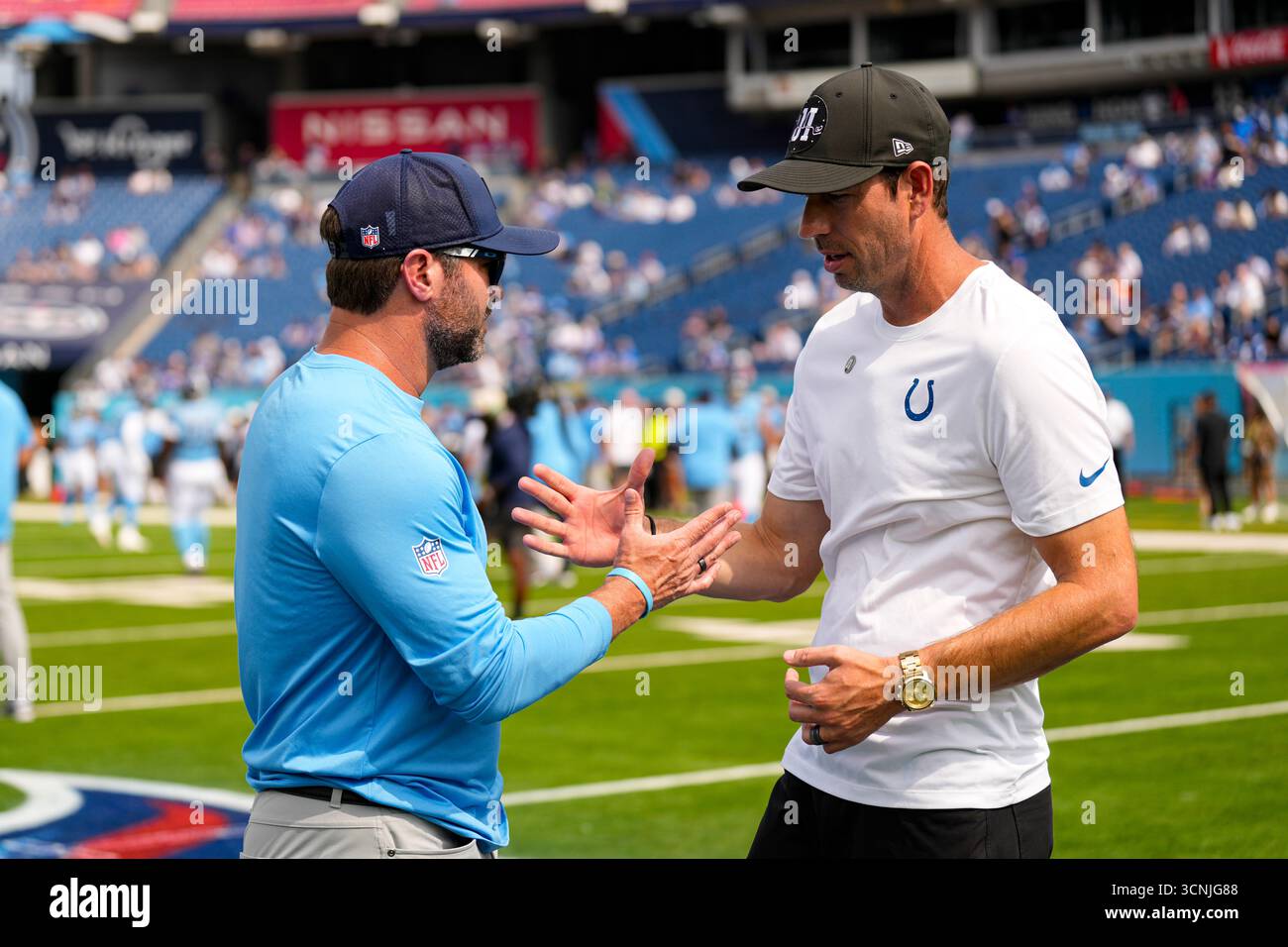 Tennessee Titans head coach Brian Callahan, left, shakes hands with ...