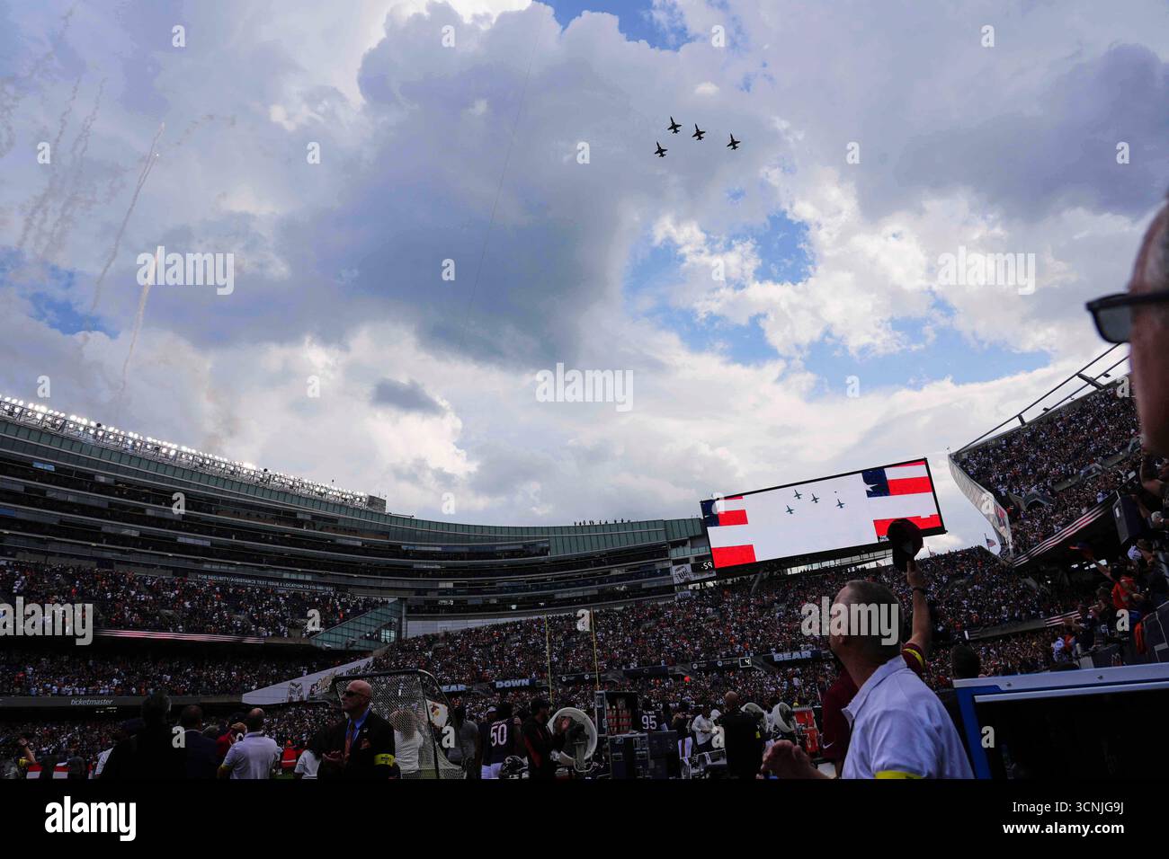 Military aircraft fly over Soldier Field during the playing of the ...