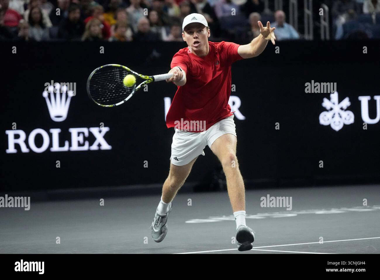 Team World's Alex Michelsen, of the United States, returns a shot ...