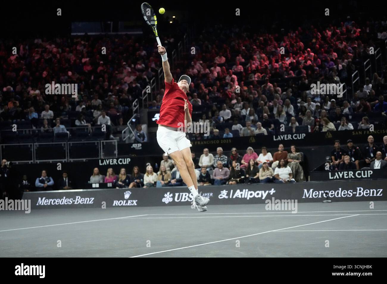 Team World's Alex Michelsen, of the United States, returns a shot ...