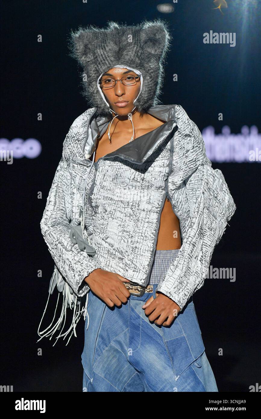 A model walks the runway wearing a design by ...