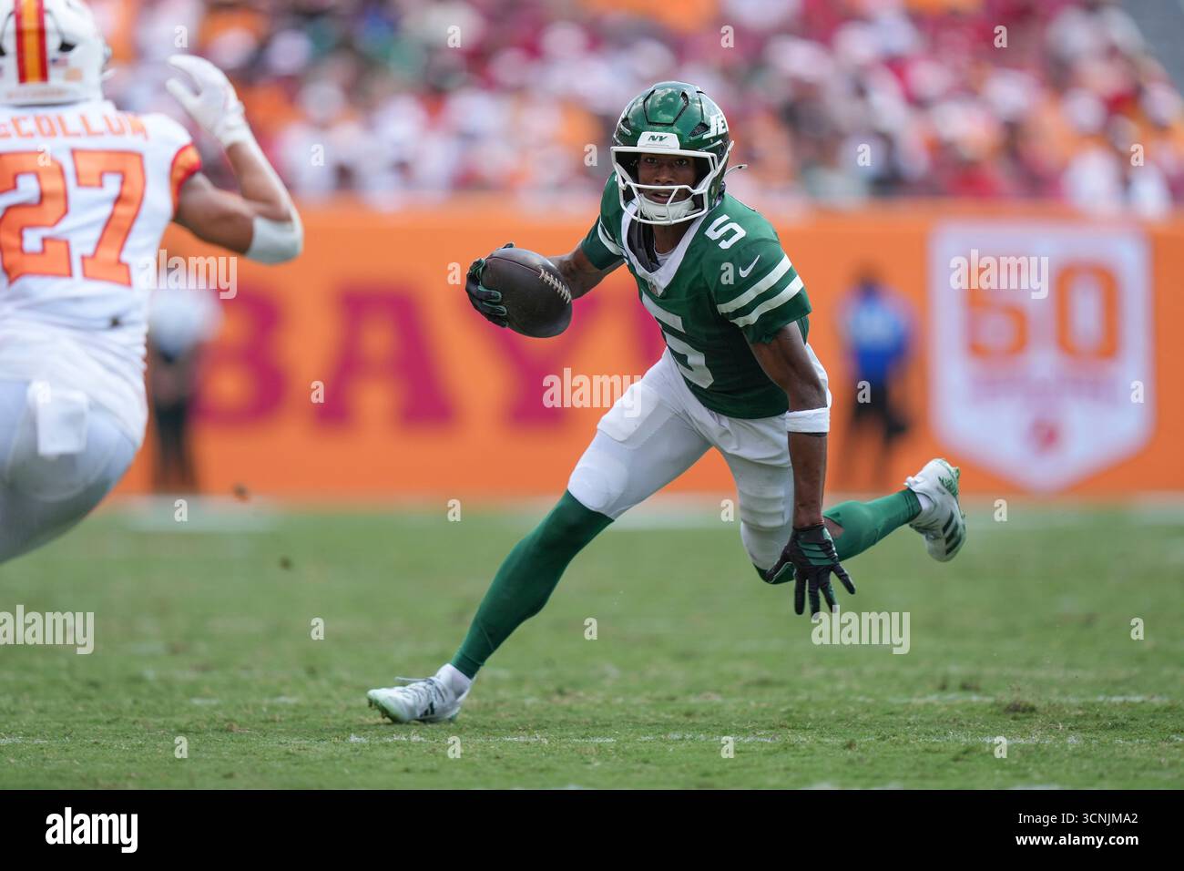 New York Jets wide receiver Garrett Wilson (5) runs after a catch ...