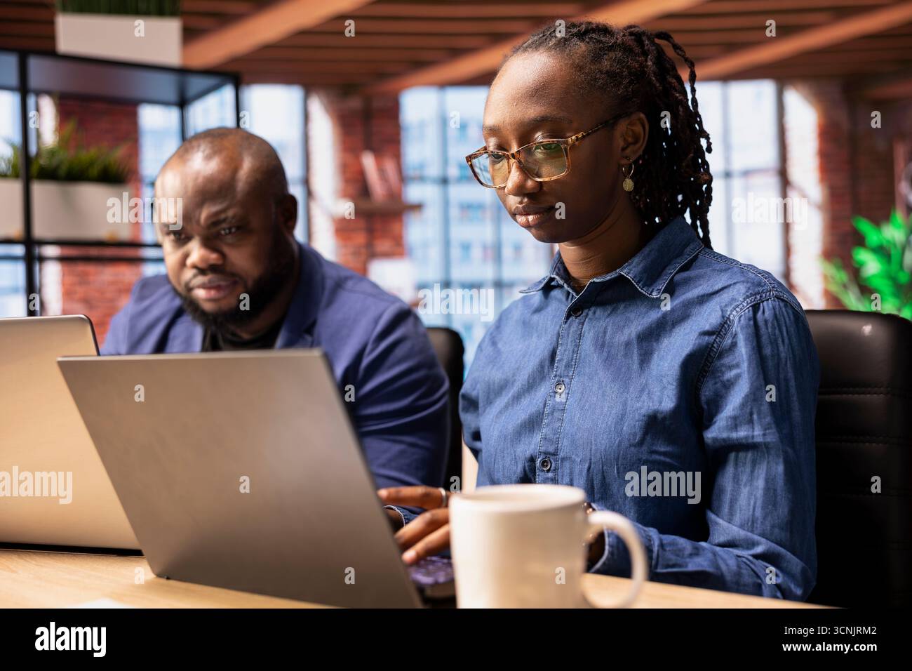 African American people at their modern desk working on a freelance ...
