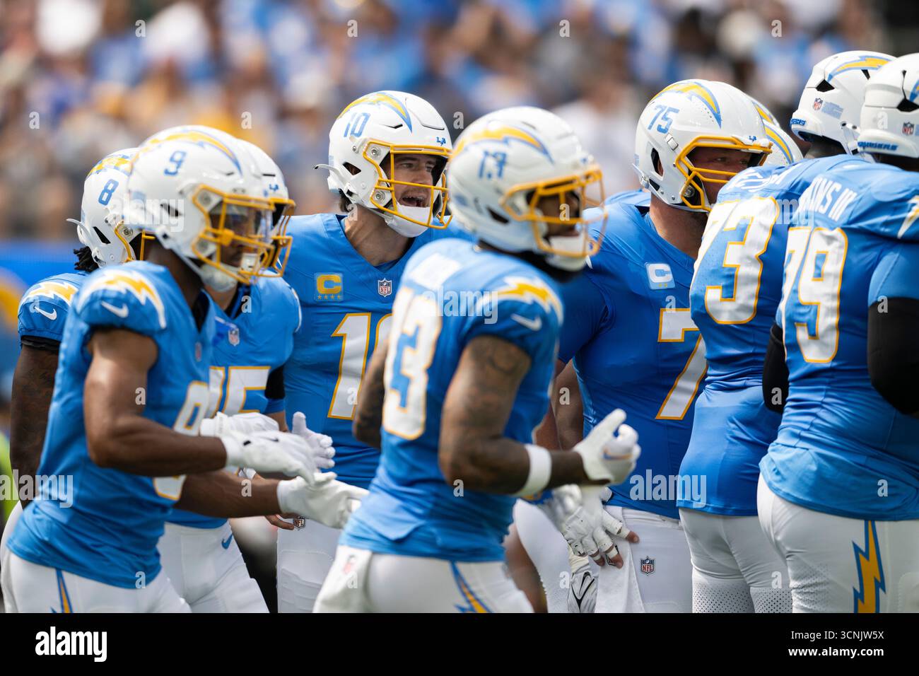 Los Angeles Chargers players huddle during an NFL football game against ...