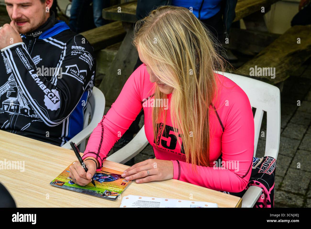 Reserve Rider Nynke Sijbesma (17) of The Netherlands signs an autograph ...