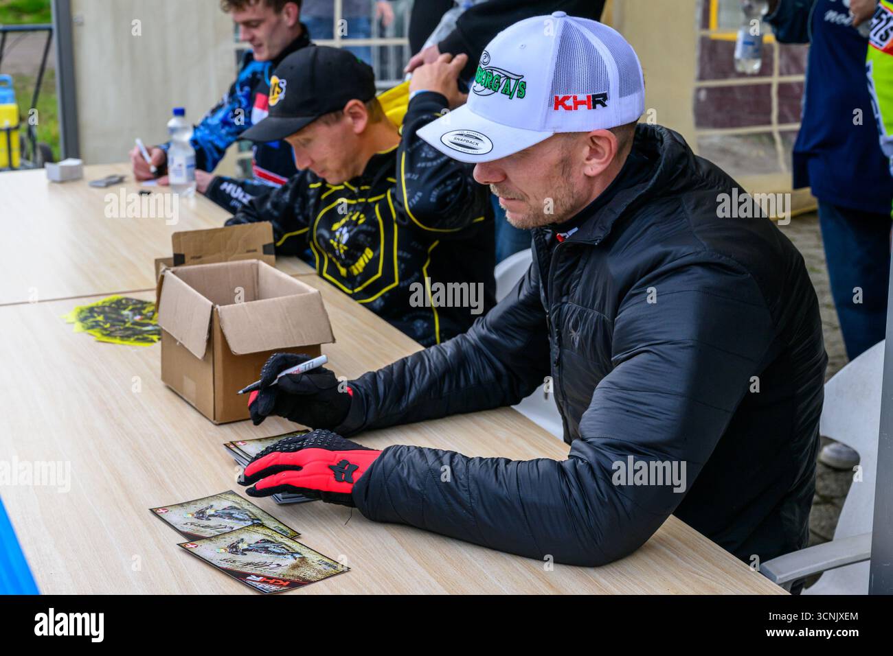 Kenneth Kruse Hansen (333) of Denmark signs autographs during the ...