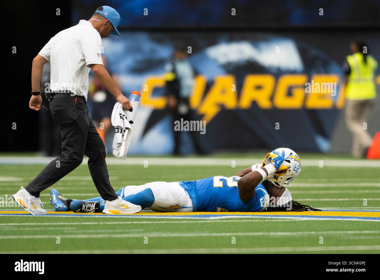Los Angeles Chargers running back Najee Harris, right, lays on the ...
