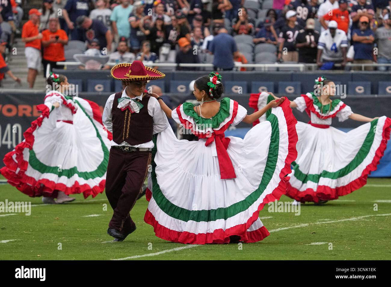 Folklorico dancers perform at halftime of an NFL football game between ...