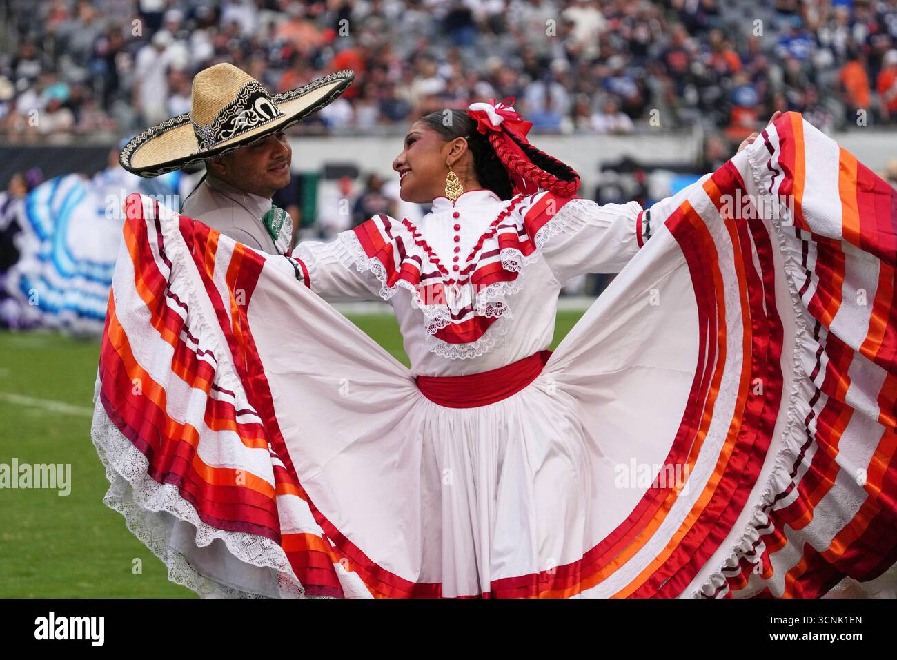 Folklorico dancers perform at halftime of an NFL football game between ...