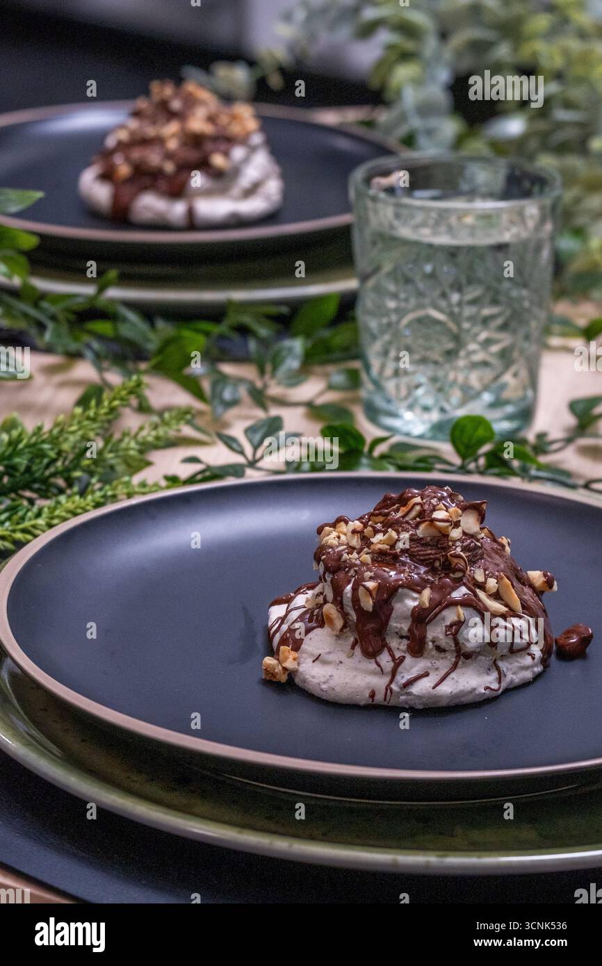 Meringue dessert features a luscious chocolate drizzle and nut topping ...