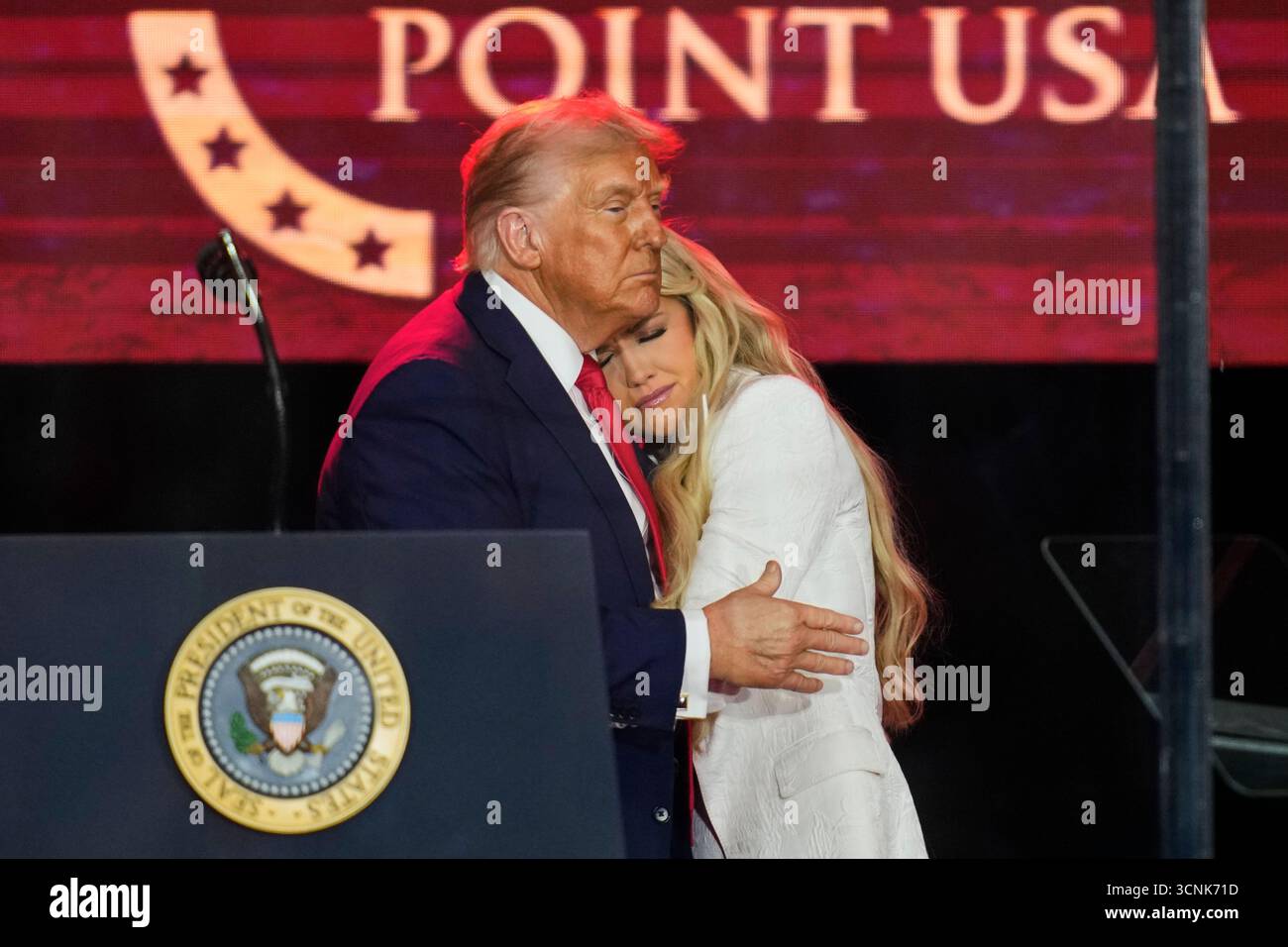 President Donald Trump embraces Erika Kirk at a memorial for ...