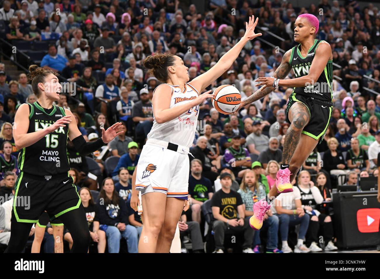 Minnesota Lynx guard Courtney Williams, right, passes the ball around ...