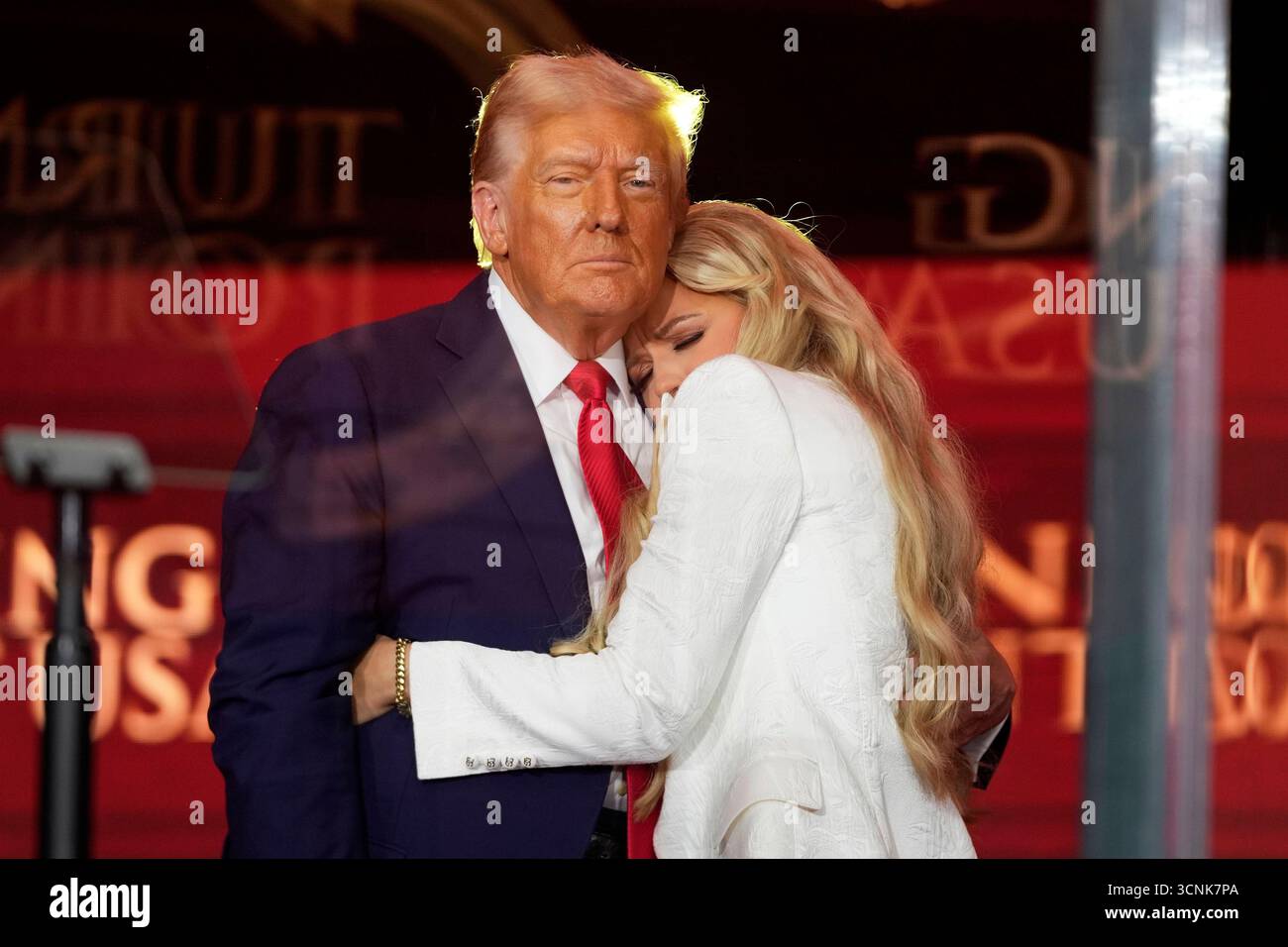 President Donald Trump, left, hugs Erika Kirk at the memorial of her ...