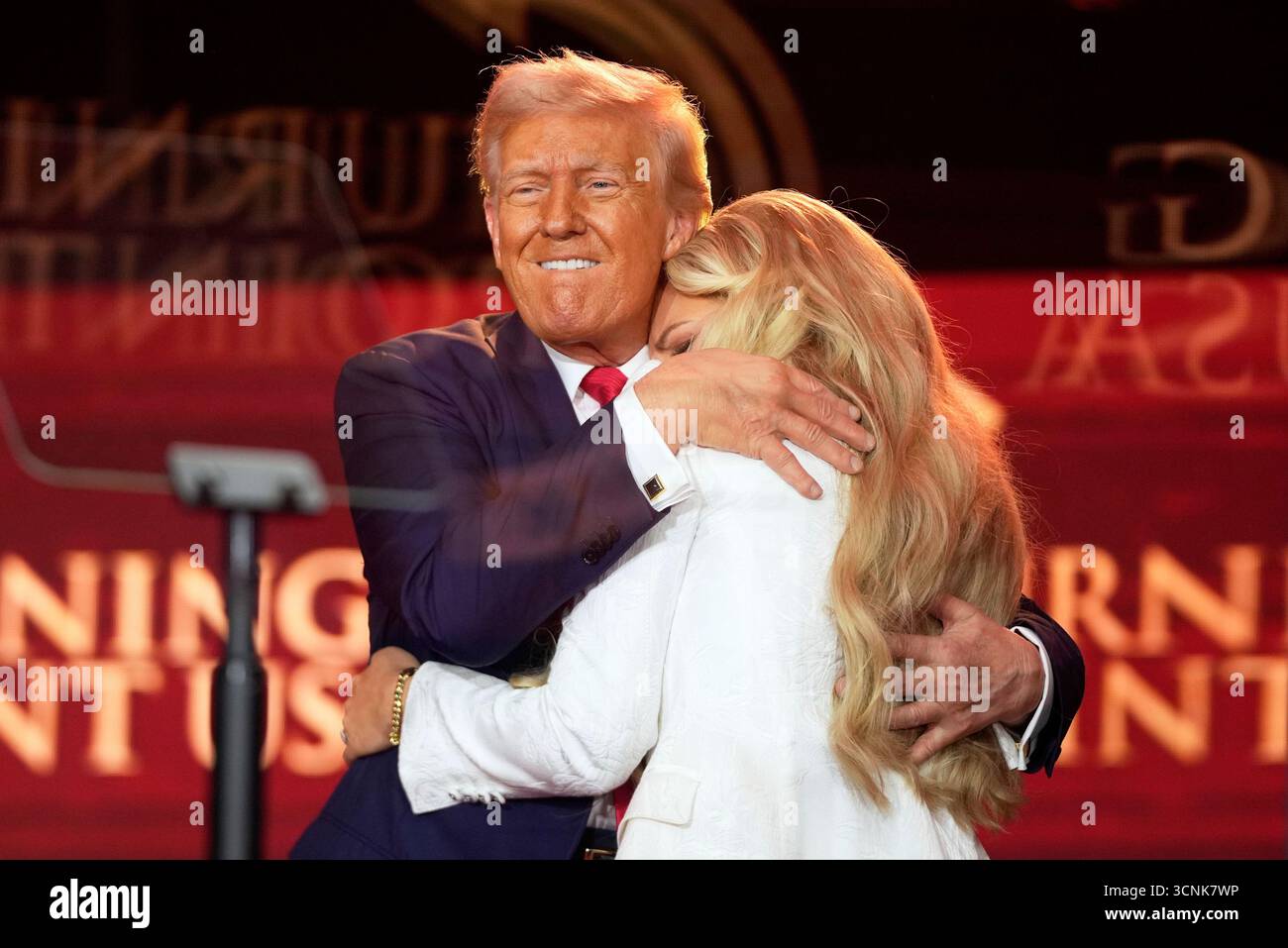 President Donald Trump, left, hugs Erika Kirk at the memorial of her ...