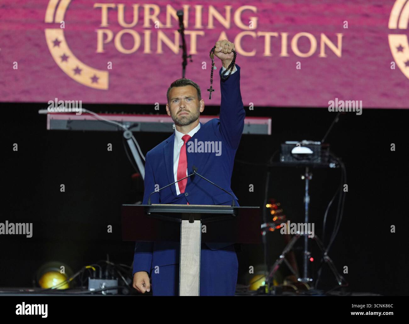 Jack Posobiec speaks at a memorial for Charlie Kirk, Sunday, Sept. 21, 2025, at State Farm ...