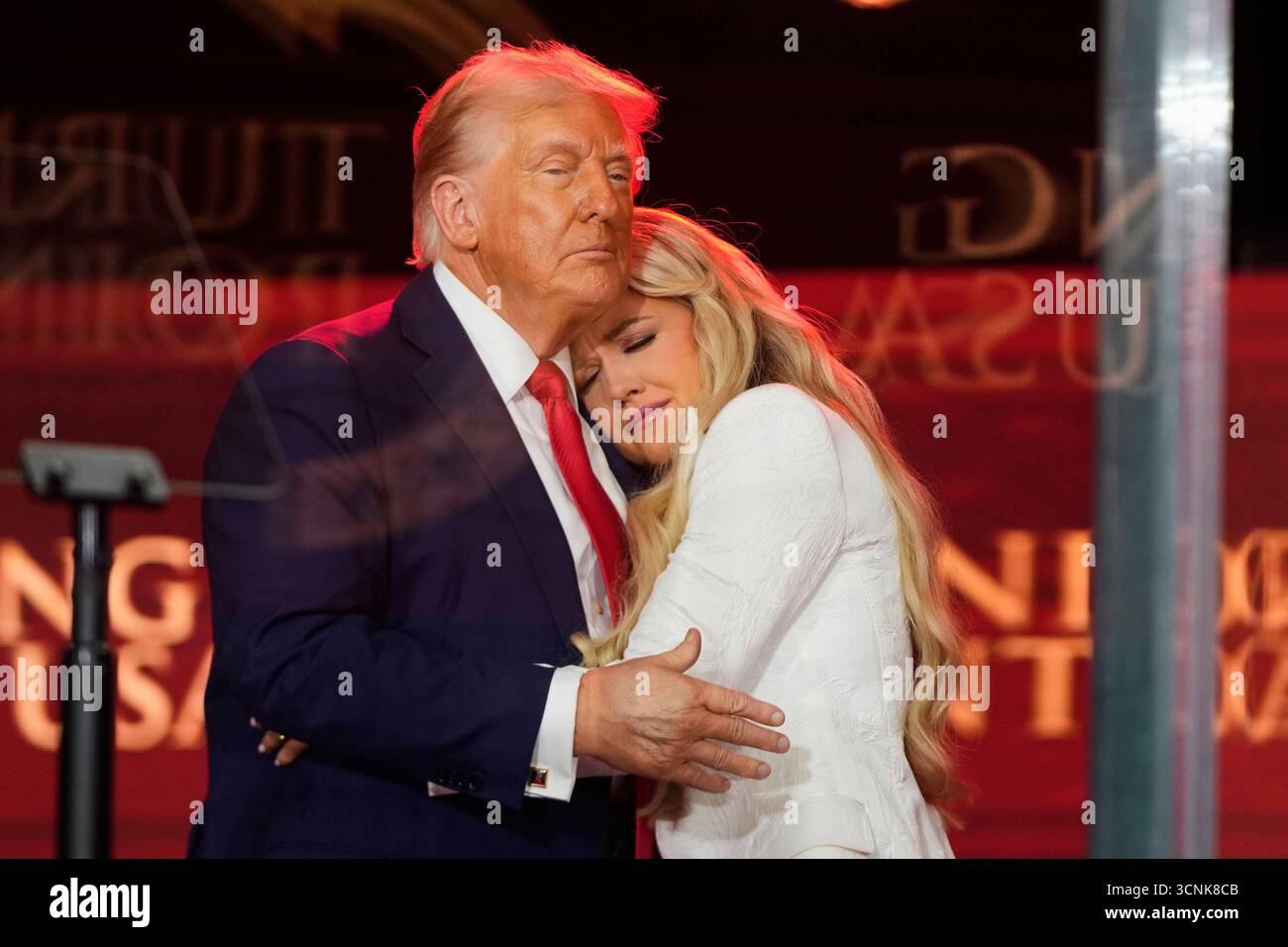 President Donald Trump, left, hugs Erika Kirk at the memorial of her ...