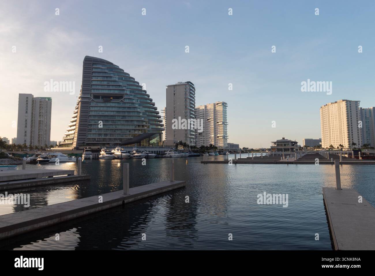 A dusk scene of a rich neighborhood knowed as puerto cancun with modern ...