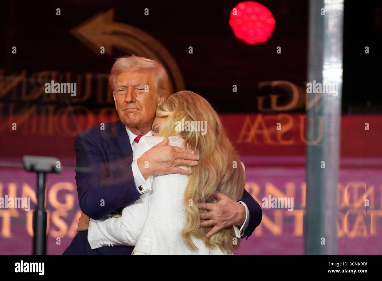 President Donald Trump, left, hugs Erika Kirk at the conclusion of a ...