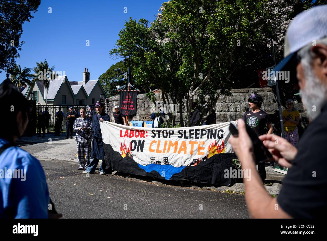Protestors hold placards during the Australian Youth Climate Coalition ...