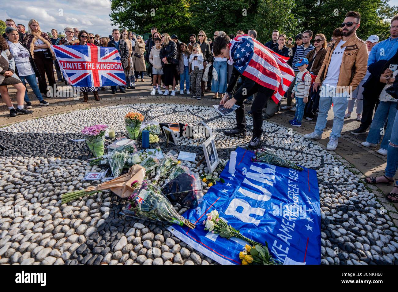 A mourner lays flowers to the recently-murdered Charlie Kirk in Hyde ...