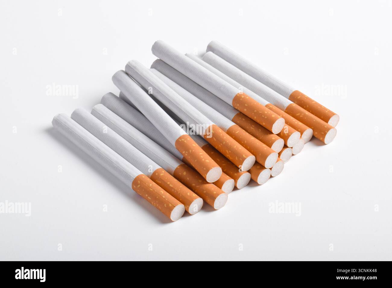 Pile of cigarettes isolated on white background Stock Photo - Alamy