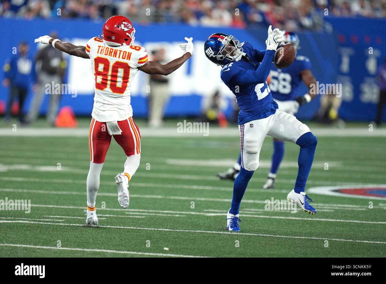 New York Giants cornerback Paulson Adebo, right, is unable to intercept a pass intended for ...