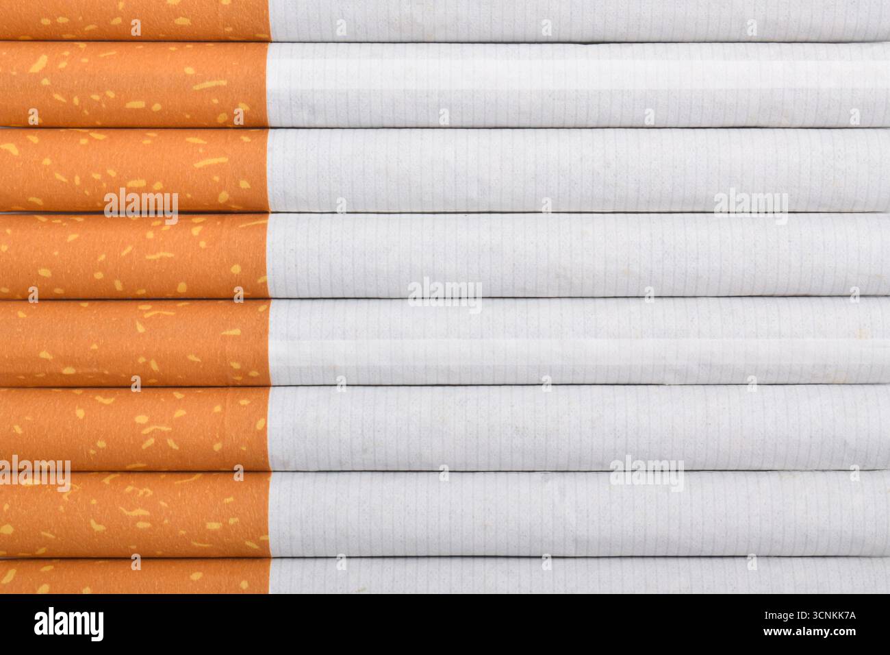 Close up of stacked cigarettes with brown filters and white paper ...