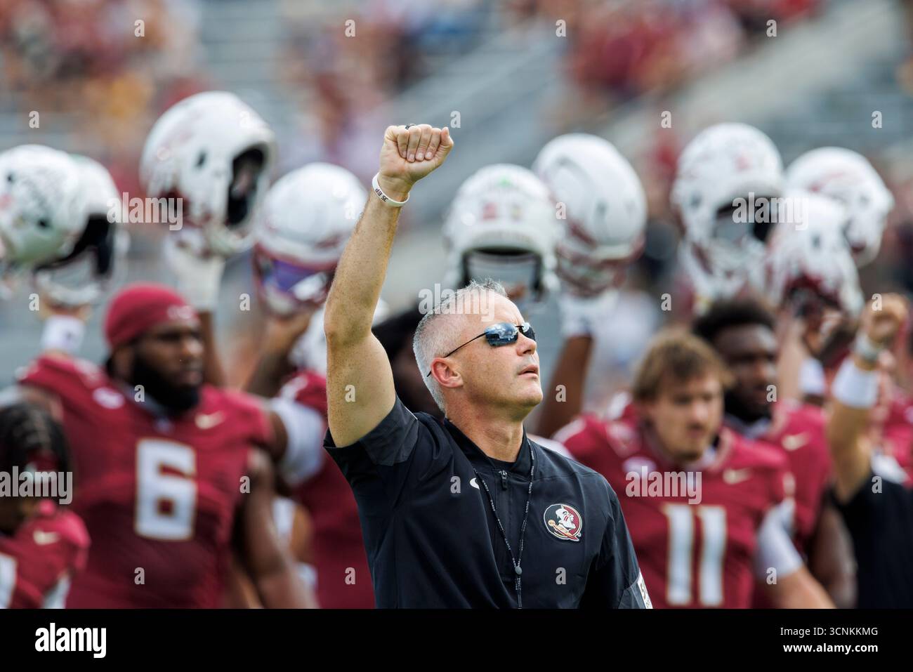Florida State head coach Mike Norvell leads his team off the field ...