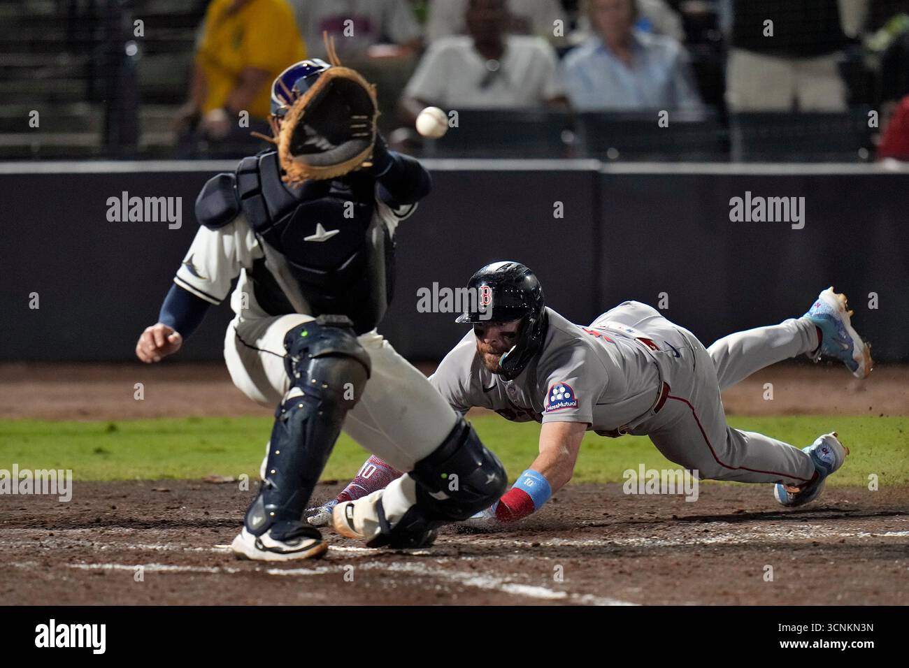 Boston Red Sox's Trevor Story, right, scores ahead of the throw to ...