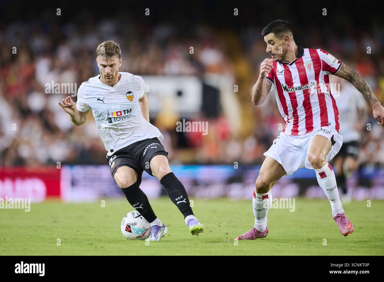 Lucas Beltran of Valencia CF and Yuri Berchiche of Athletic Club during ...