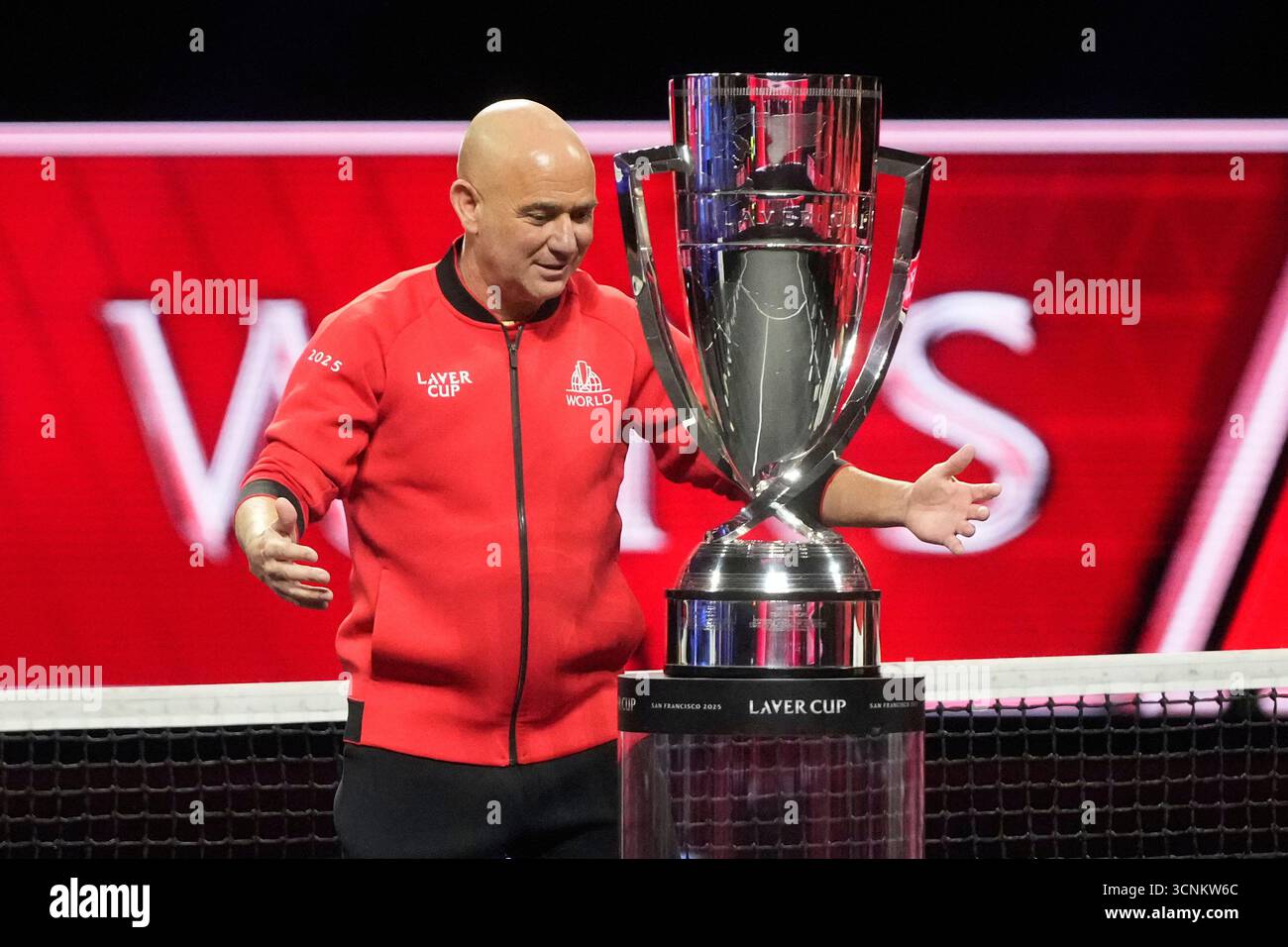 Team World captain Andre Agassi reacts behind the Laver Cup Trophy ...