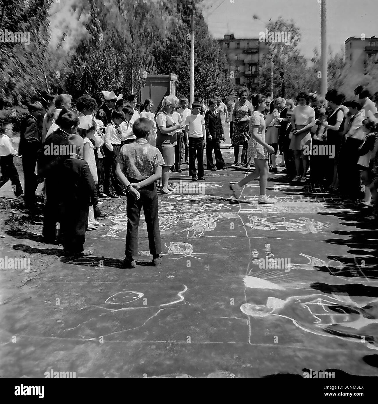 An atmospheric black-and-white photograph captures a chalk drawing on ...