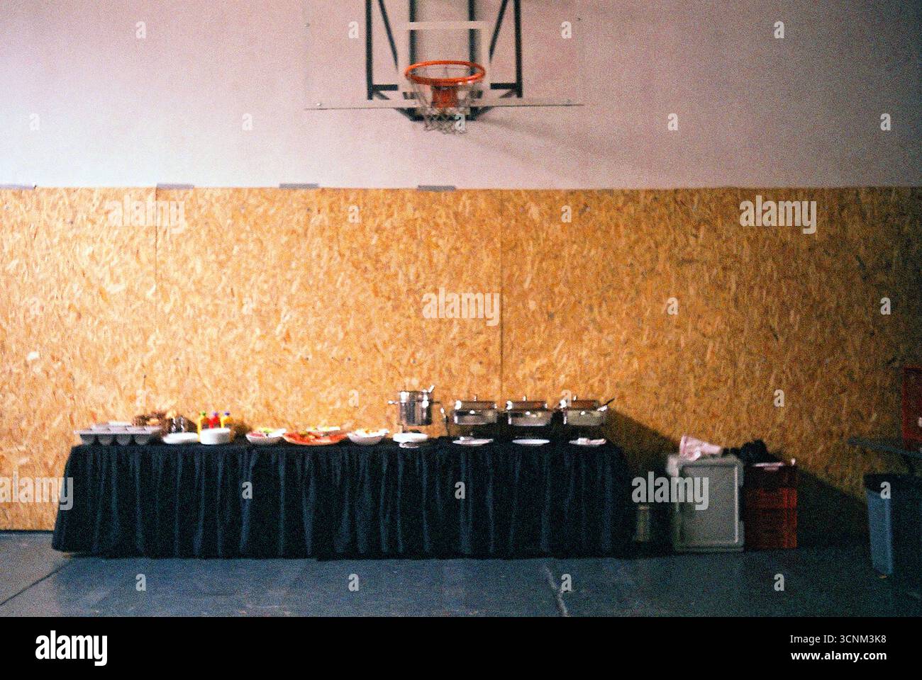 Analog documentary photo of catering setup in a basketball hall ...