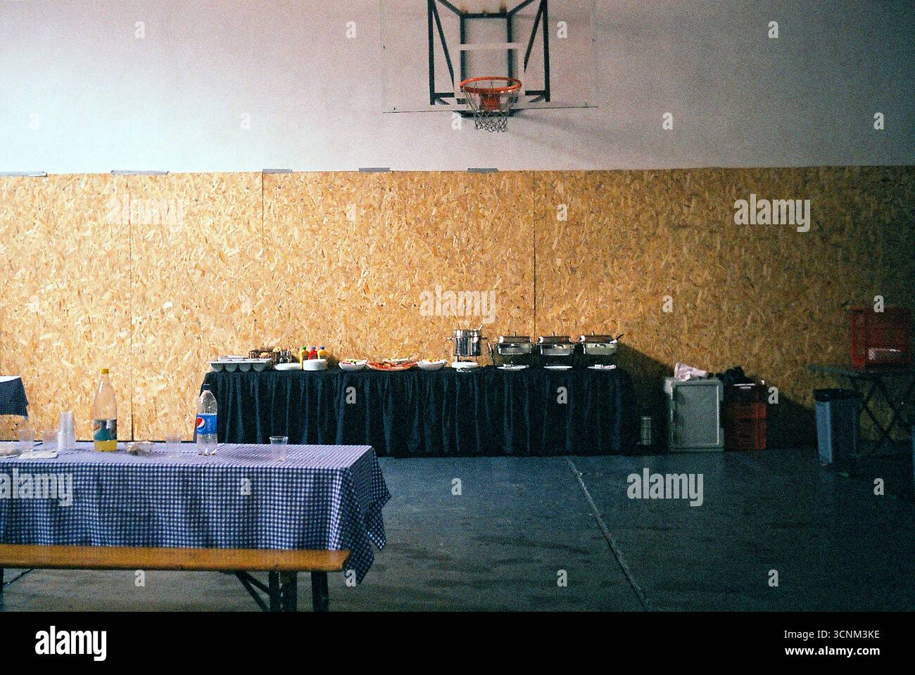Analog documentary photo of catering setup in a basketball hall ...