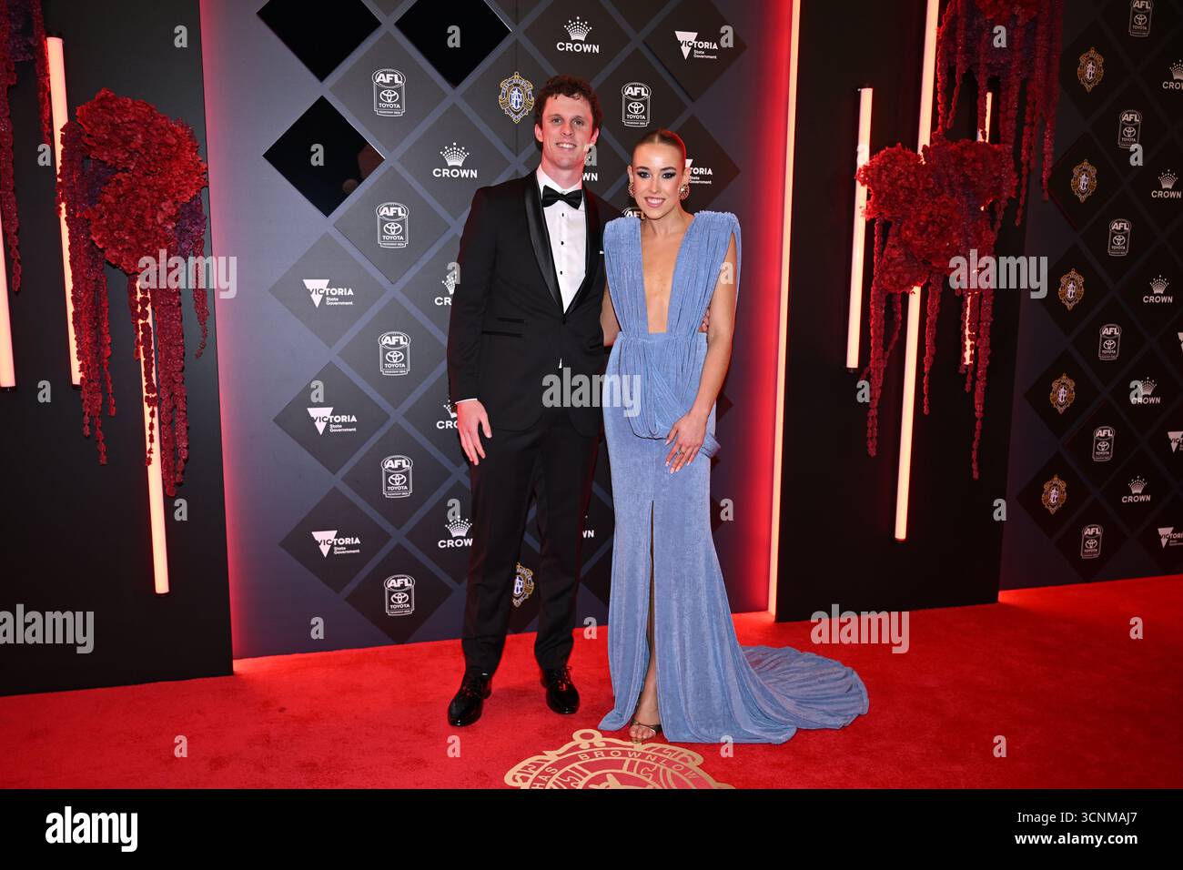 Geelongs Max Holmes with partner Jess Butler during the 2025 Brownlow Medal ceremony at Crown ...