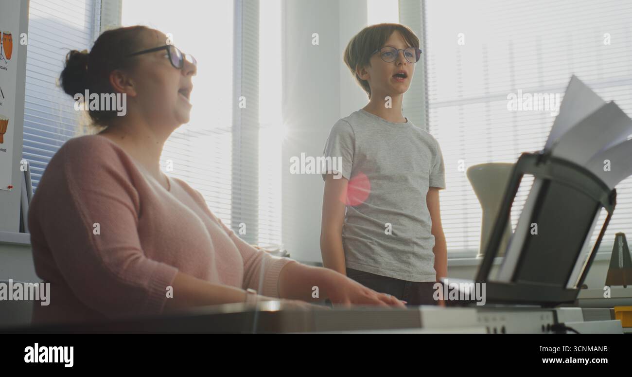 Teacher play piano boy sing hi-res stock photography and images - Alamy